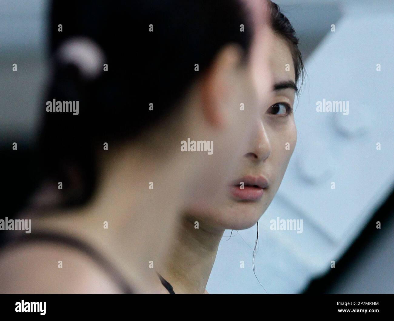 Guo Jingjing of China looks at her teammate Wu Minxia before diving in ...