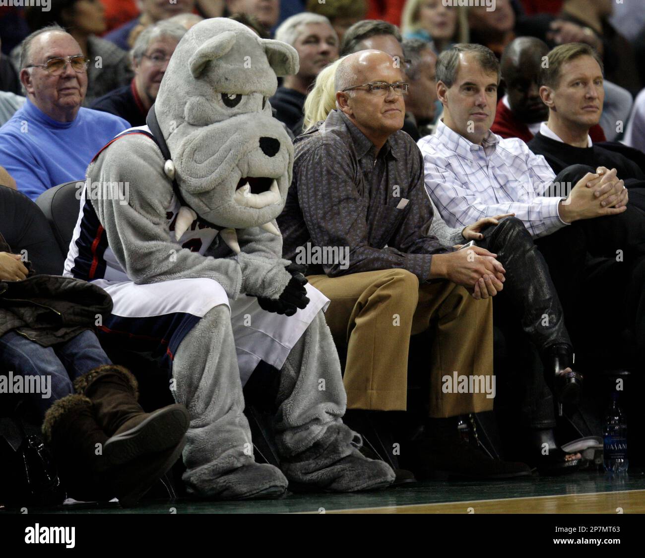 "Spike," left, the Gonzaga mascot, joins fans in the courtside seats ...