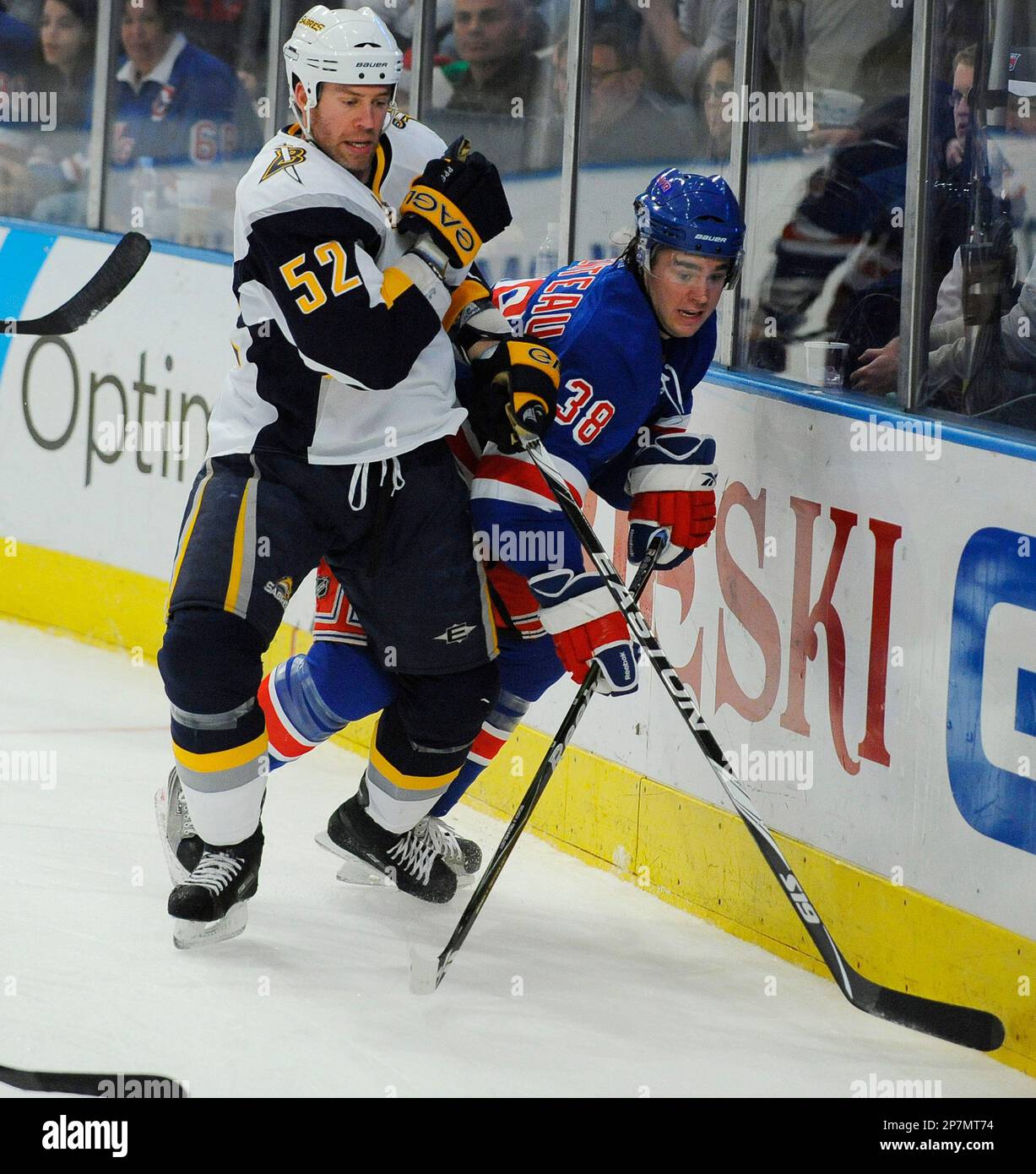 New York Rangers' P.A. Parenteau is checked by Buffalo Sabres' Craig ...