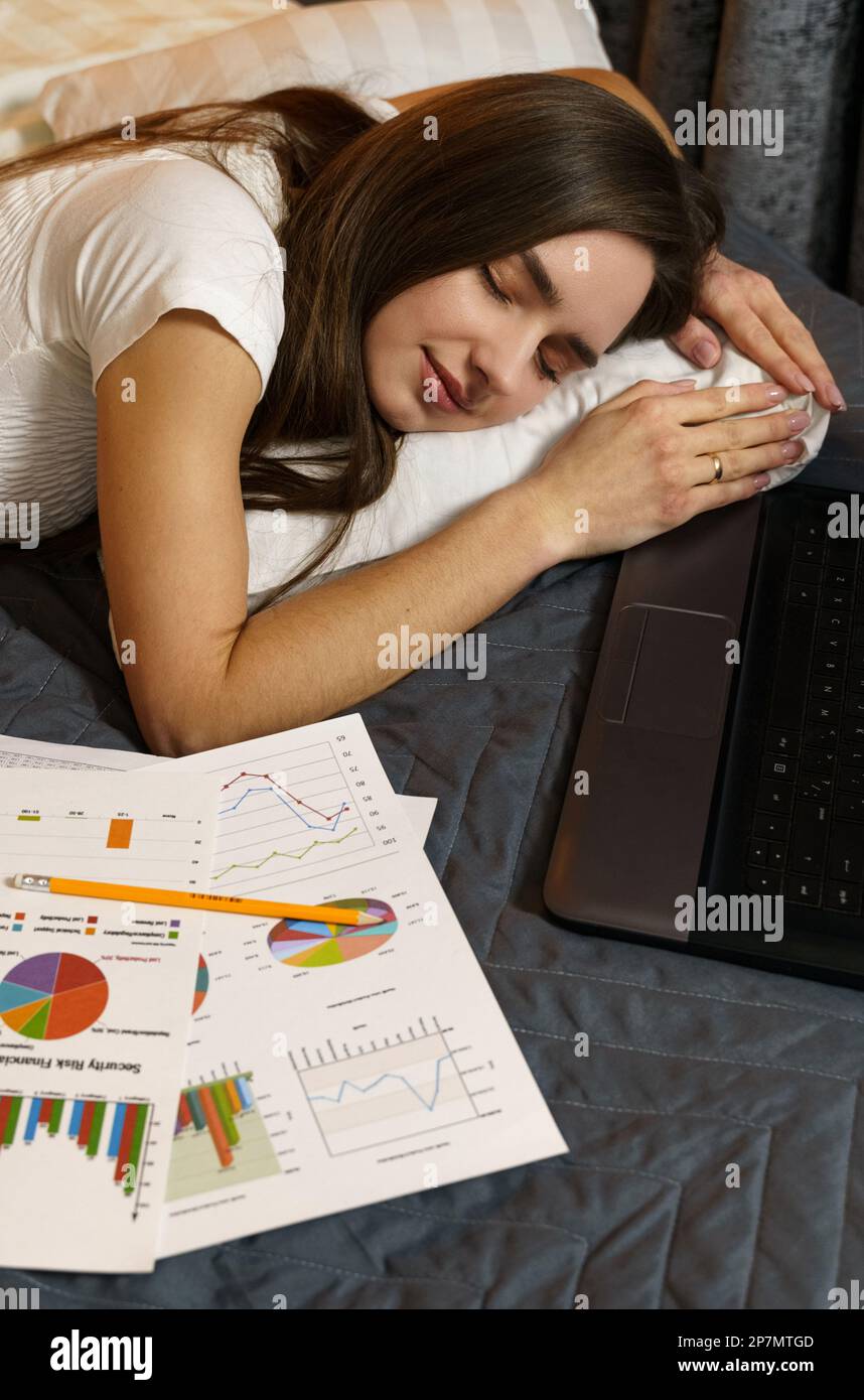 A young girl fell asleep in bed studying reporting information - work ...