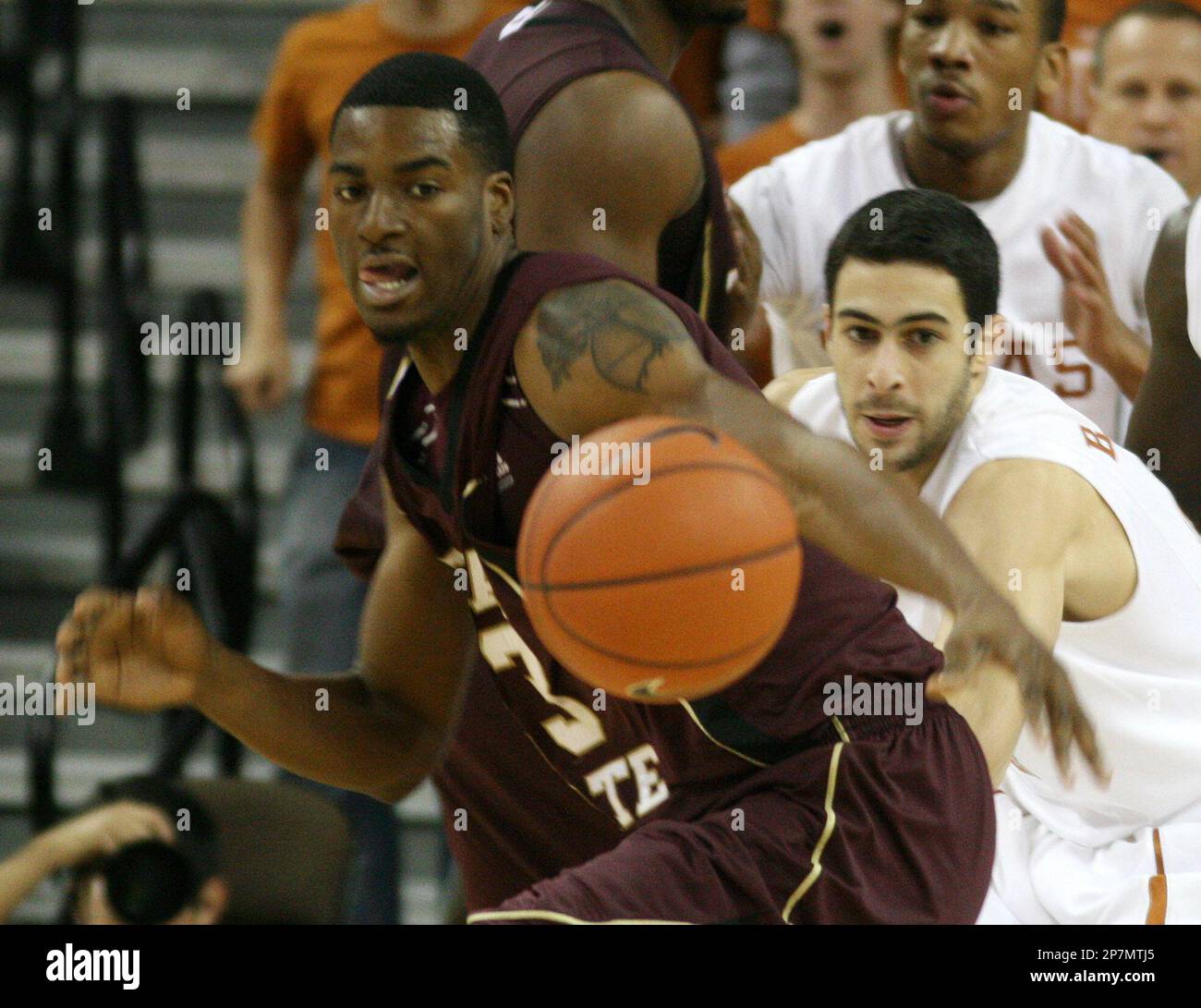 Texas State's Cameron Johnson, left, loses the ball due to pressure ...