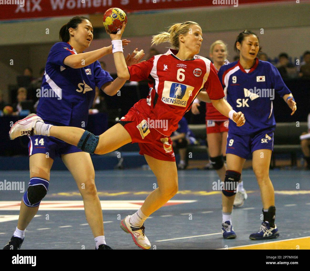 Heidi Loke of Norway, center, shoots a goal during a round Group II ...
