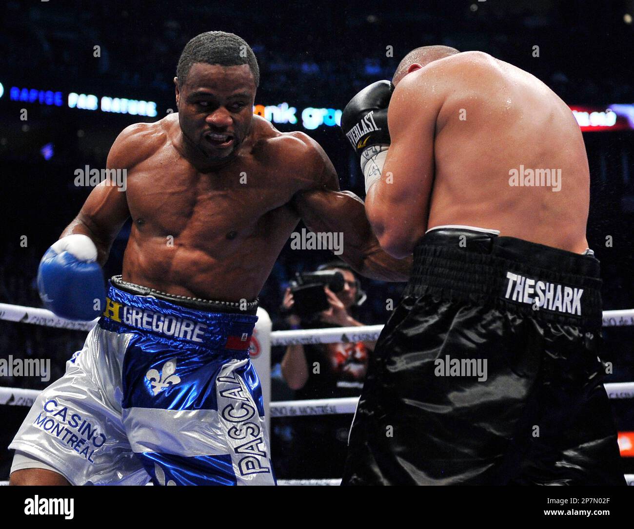 Jean Pascal, from Montreal, left, lands a body blow on Adrian Diaconu ...