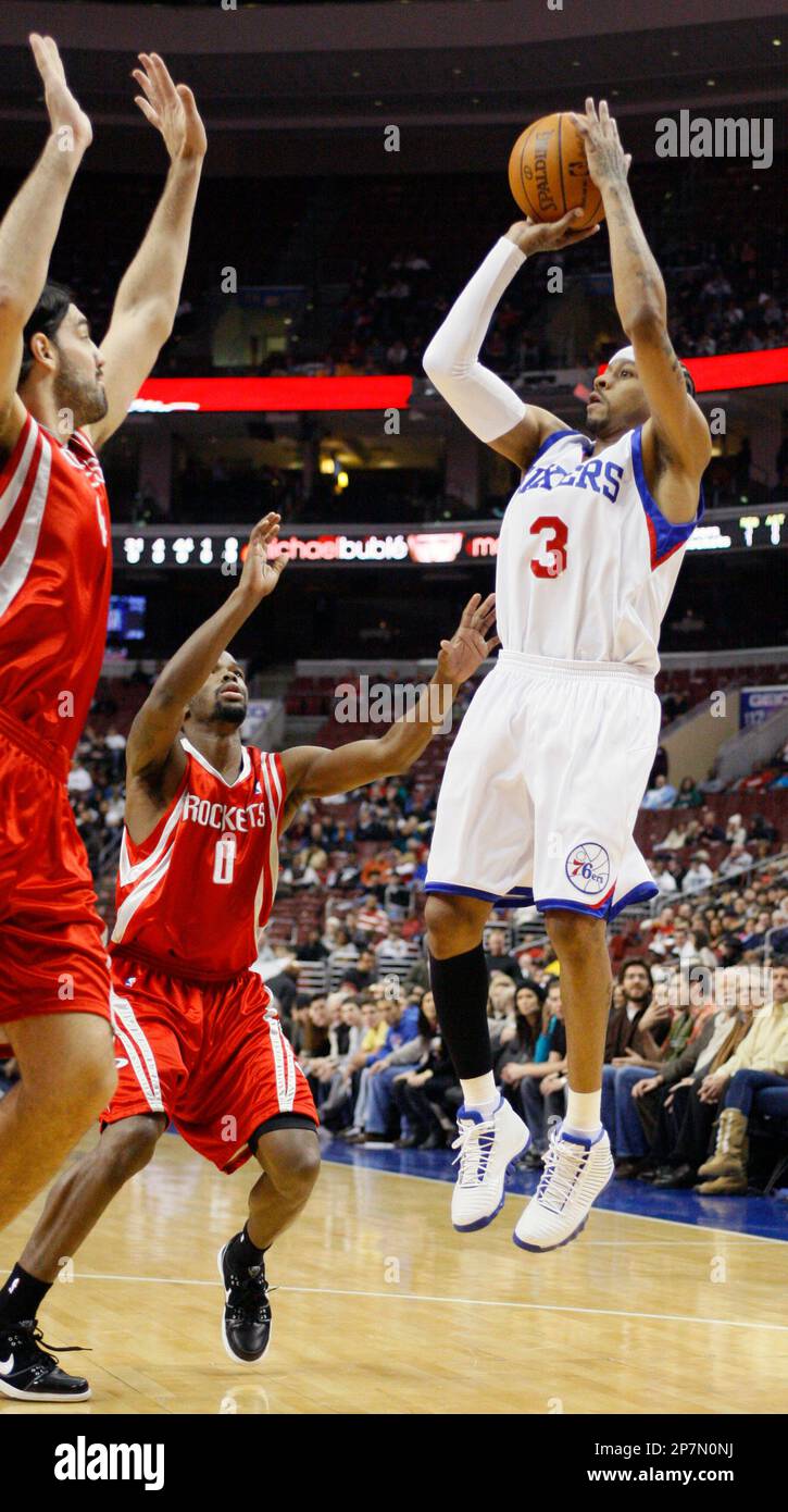 Philadelphia 76ers' Allen Iverson, right, goes up for a shot as Houston ...