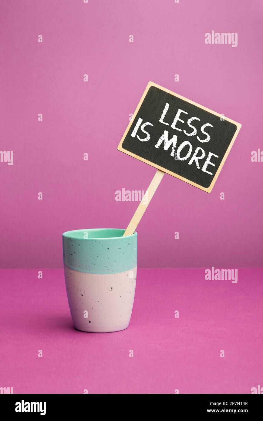 Hand writing sign Less Is More. Word Written on Minimalist approach to ...