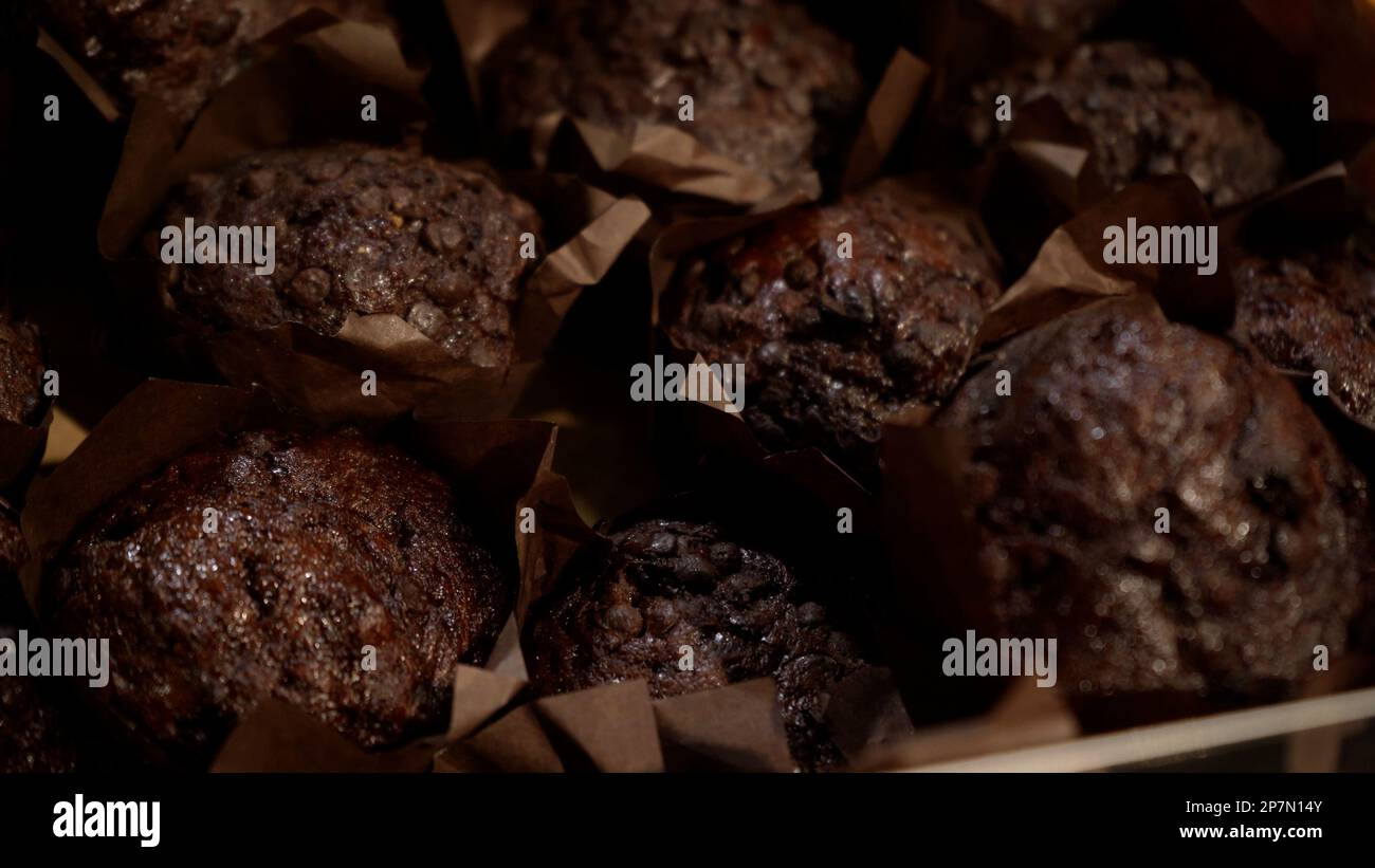 Freshly baked healthy muffins on the counter in the store. Shopping at ...