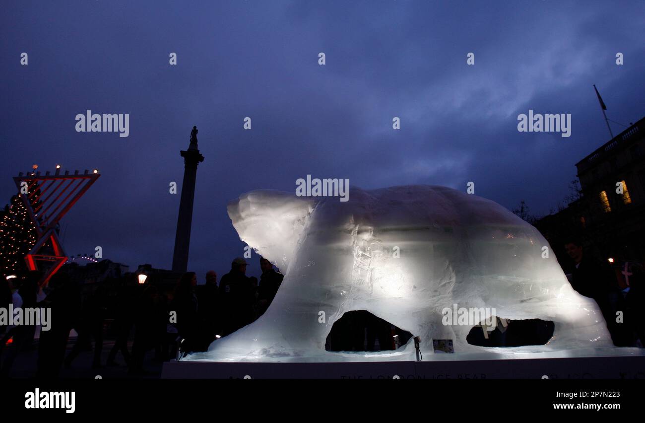 A life-sized ice sculpture of a hunting polar bear is seen at dusk as ...