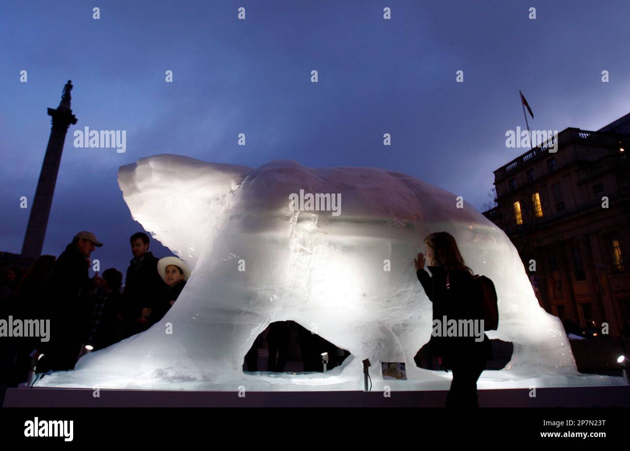 A life-sized ice sculpture of a hunting polar bear is seen at dusk as ...