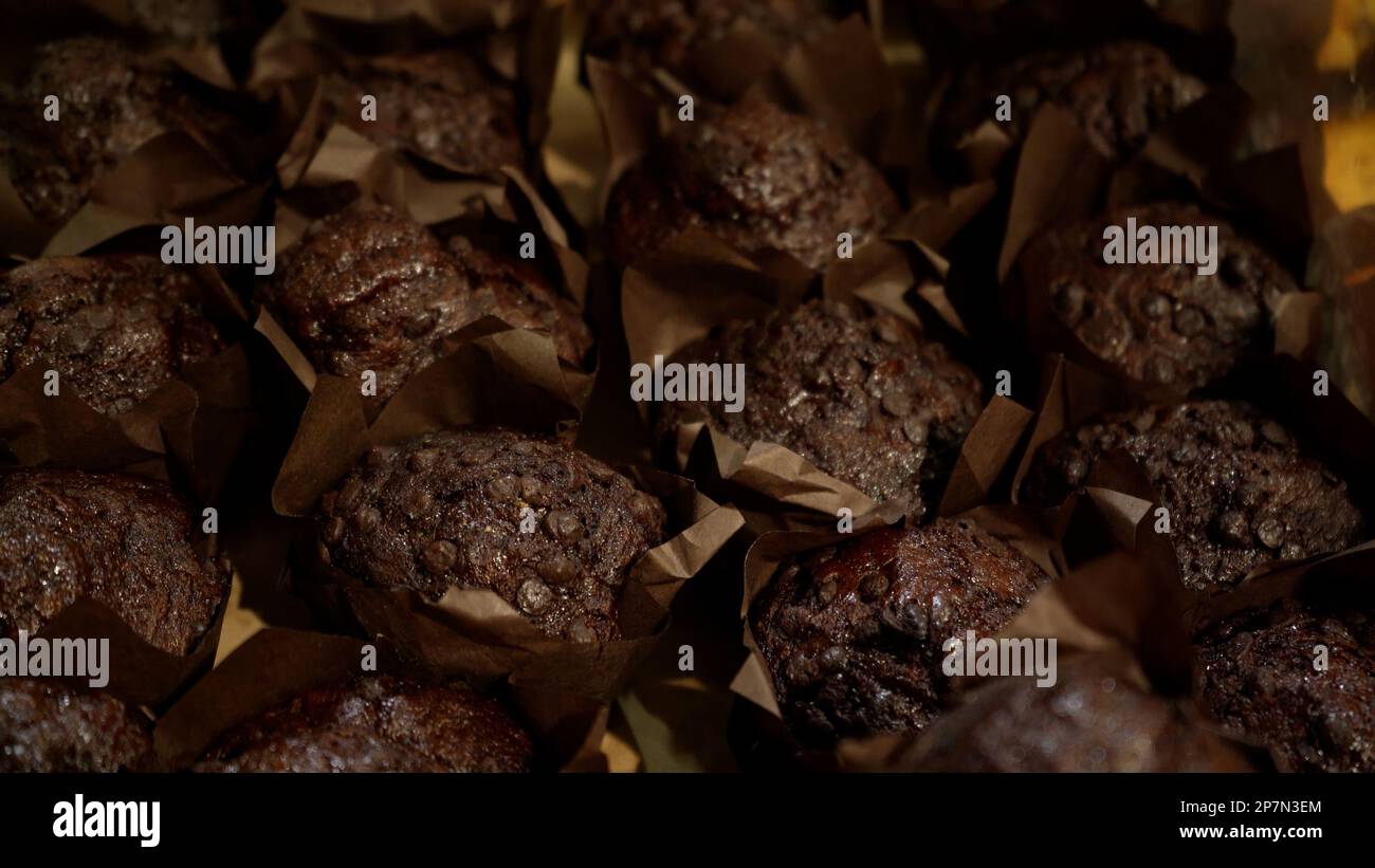 Freshly baked healthy muffins on the counter in the store. Shopping at ...