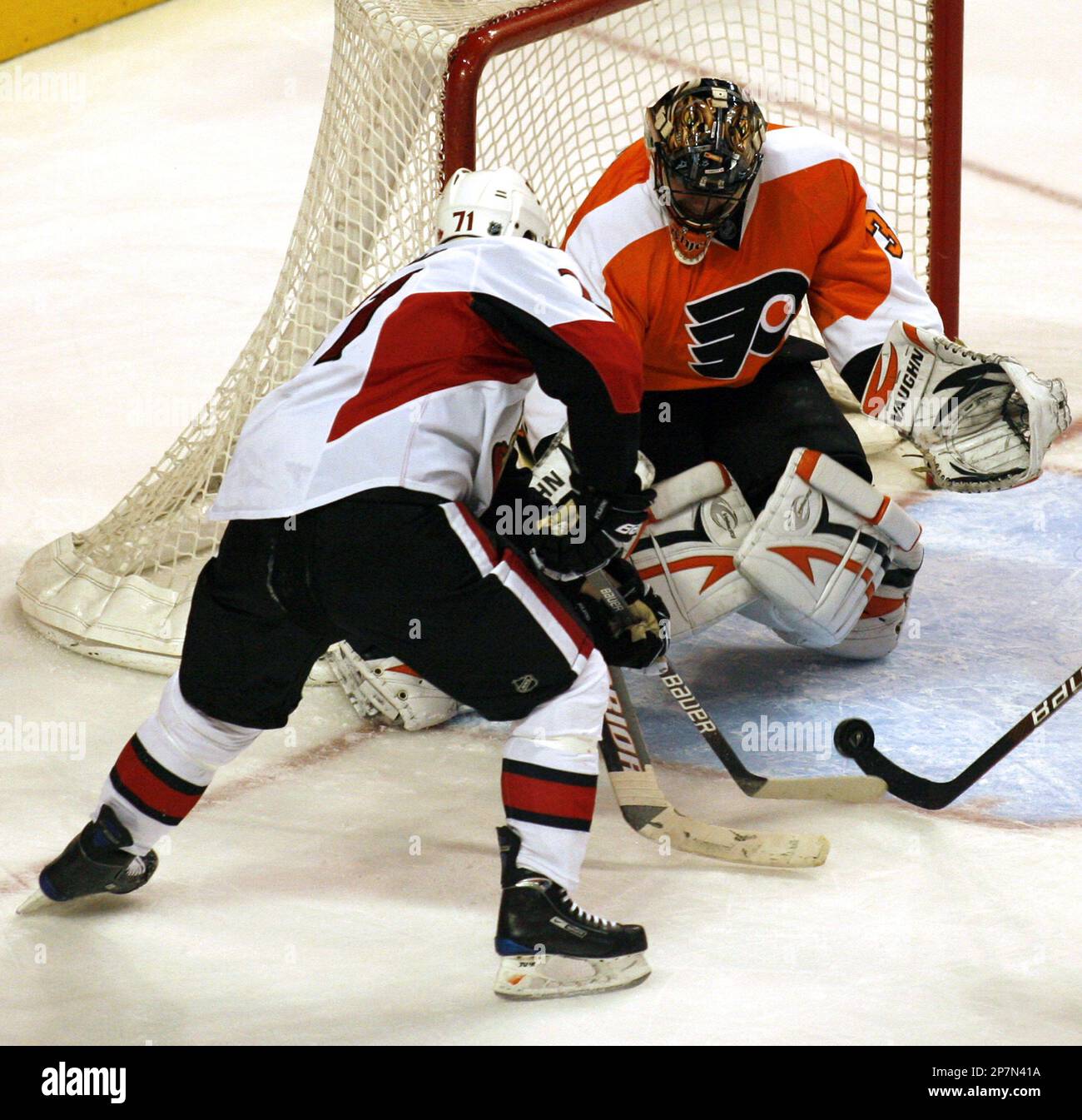 Ottawa Senators' Nick Foligno, left, sets up for a score against ...