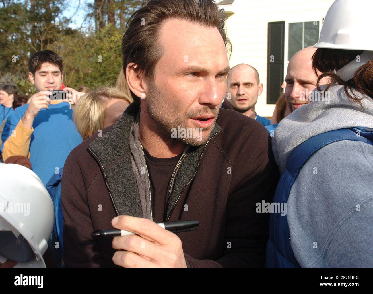 Actor Christian Slater works his way through the crowd after signing ...
