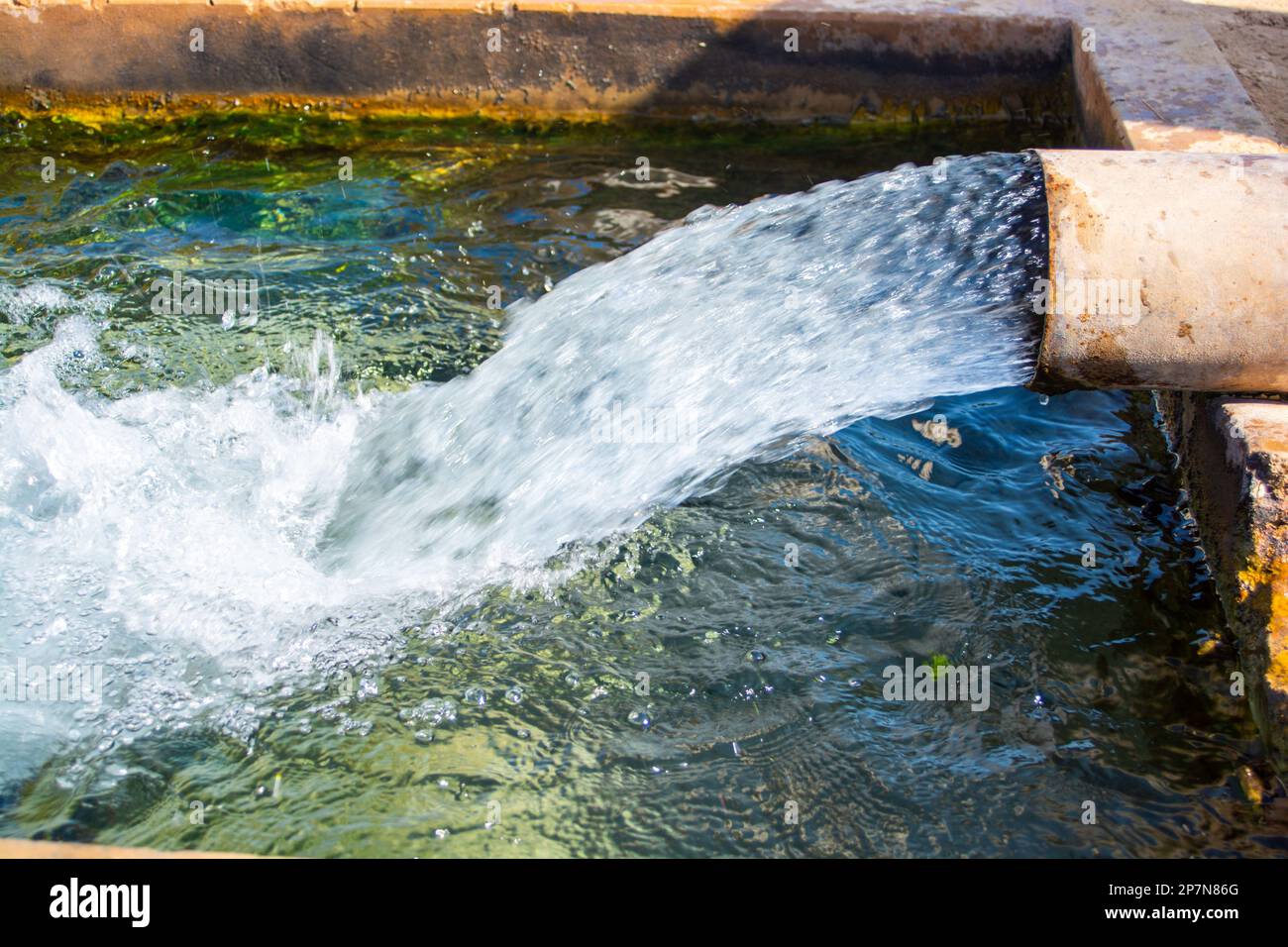 Flow of water from a solar powered tube well for irrigation Stock Photo ...