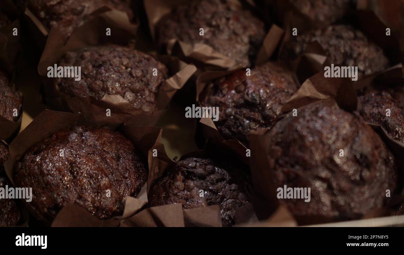 Freshly baked healthy muffins on the counter in the store. Shopping at ...