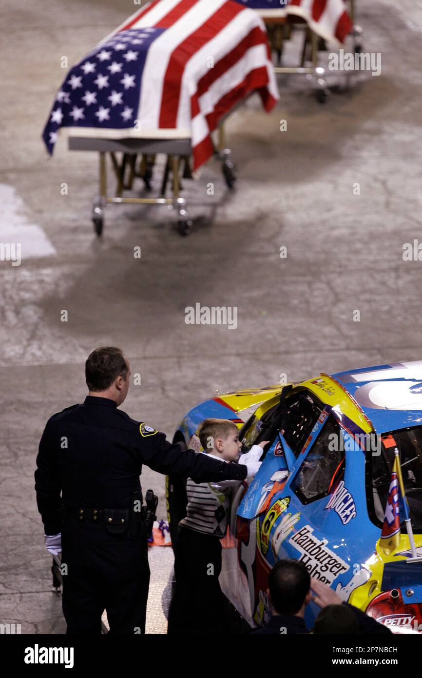 Nicholas Renninger, 3, son of Sgt. Mark Renninger, peers into a NASCAR ...