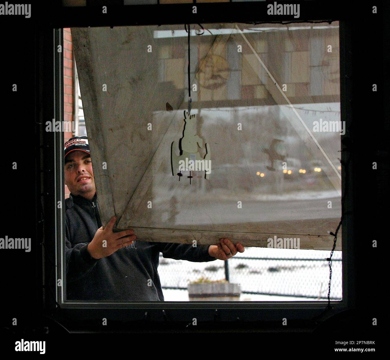 Mike Koch, an employee of Hoaks Lakeshore Restaurant, lowers a piece of ...