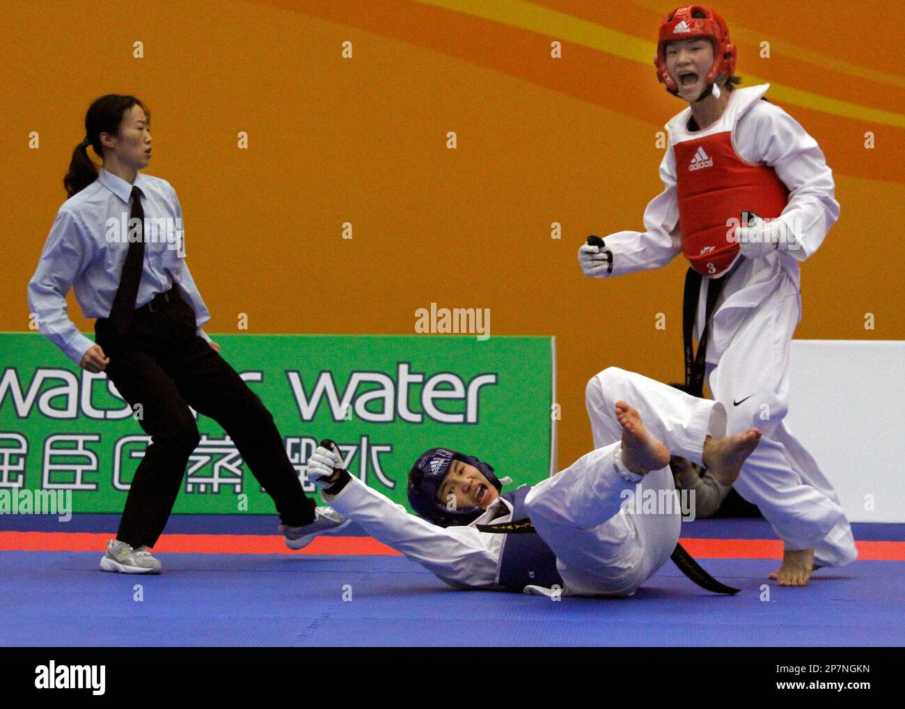 Kim Eunghyun, right, of South Korea, kicks down Erdenebaatar Naranchimeg of Mongolia in the ...
