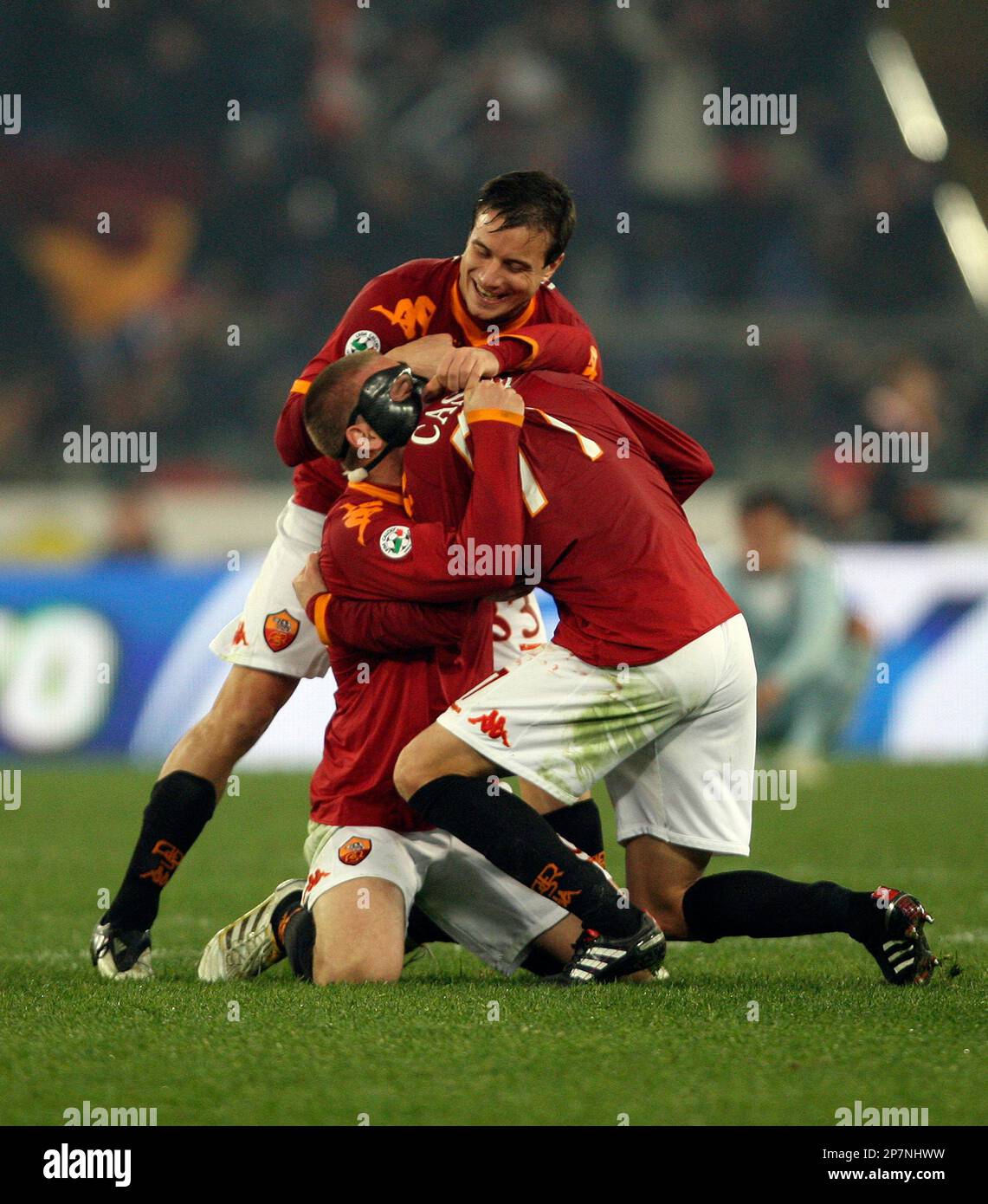 AS Roma defender Marco Cassetti, at right back to camera, is celebrated ...