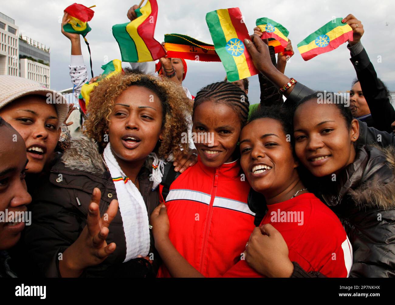 Ethiopian Mihret Begna, center, poses with fans after winning the ...