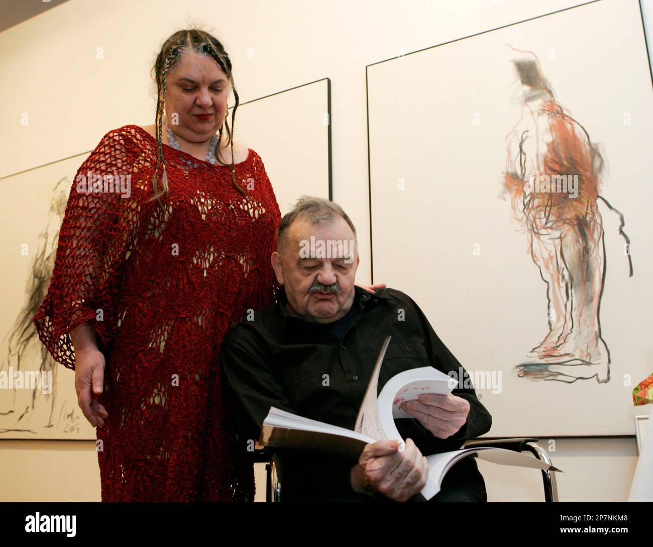 FILE - Austrian sculptur Alfred Hrdlicka, right, flips through a book ...