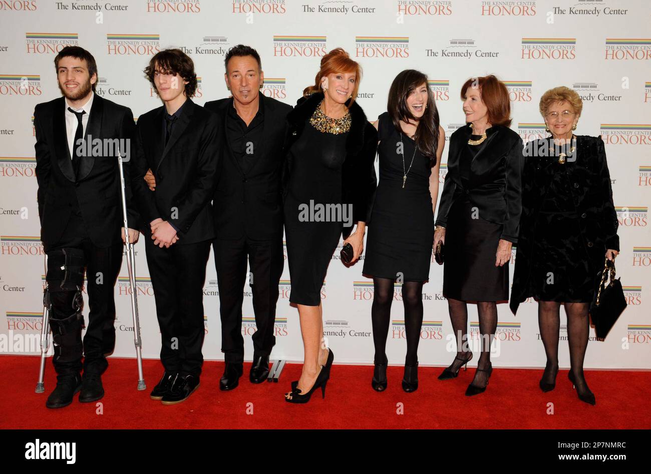 Kennedy Center Honoree singer Bruce Springsteen, second from left, poses on the red carpet with ...