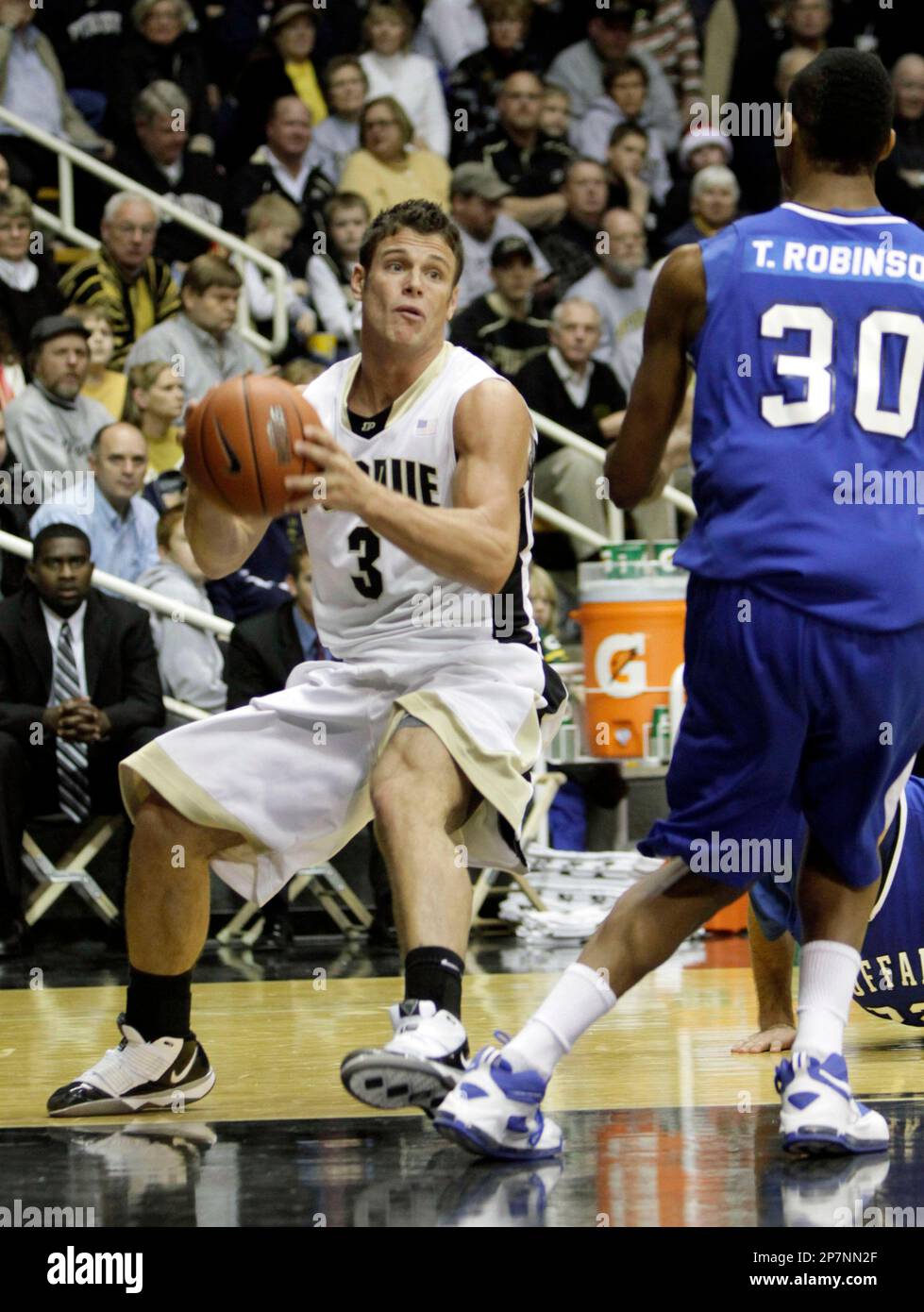 Purdue guard Chris Kramer, left, goes to the basket in front of Buffalo ...