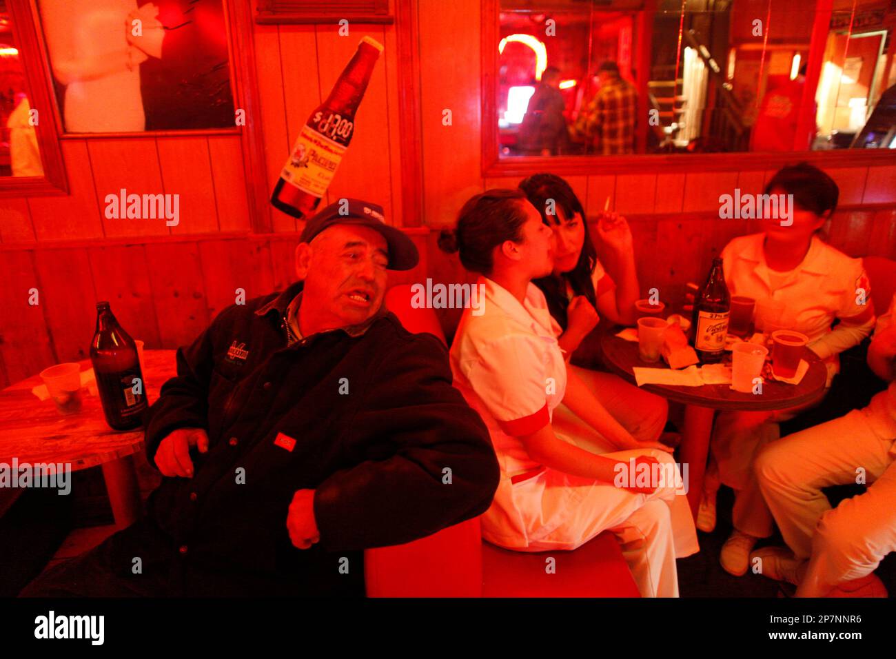 A man sings to women in a bar in downtown Tijuana, Mexico, Friday, Dec ...