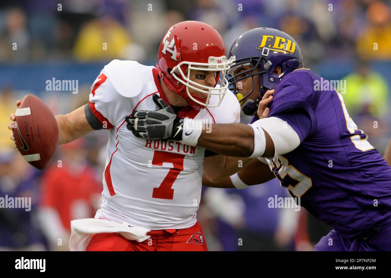 East Carolina's Scotty Robinson (53) tackles Houston's quarterback Case ...