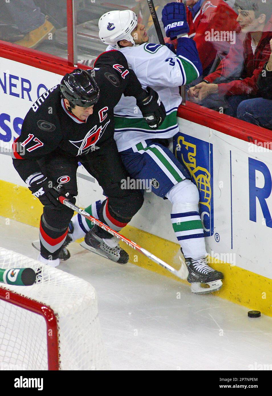 Carolina Hurricanes' Rod Brind'Amour (17) checks Vancouver Canucks ...