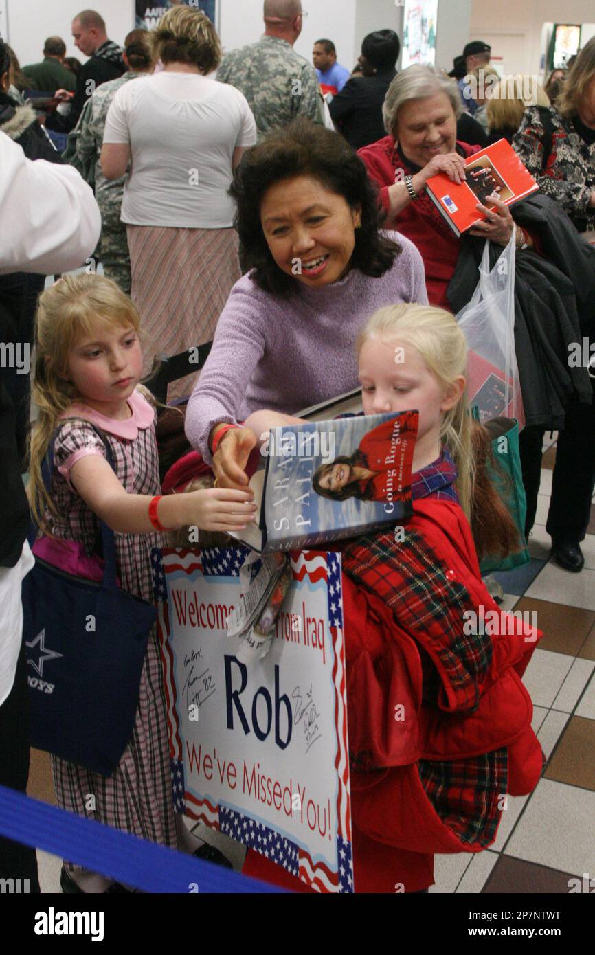 Tik Ellis, center, helps sisters Calista and Nicole Carter, left and ...