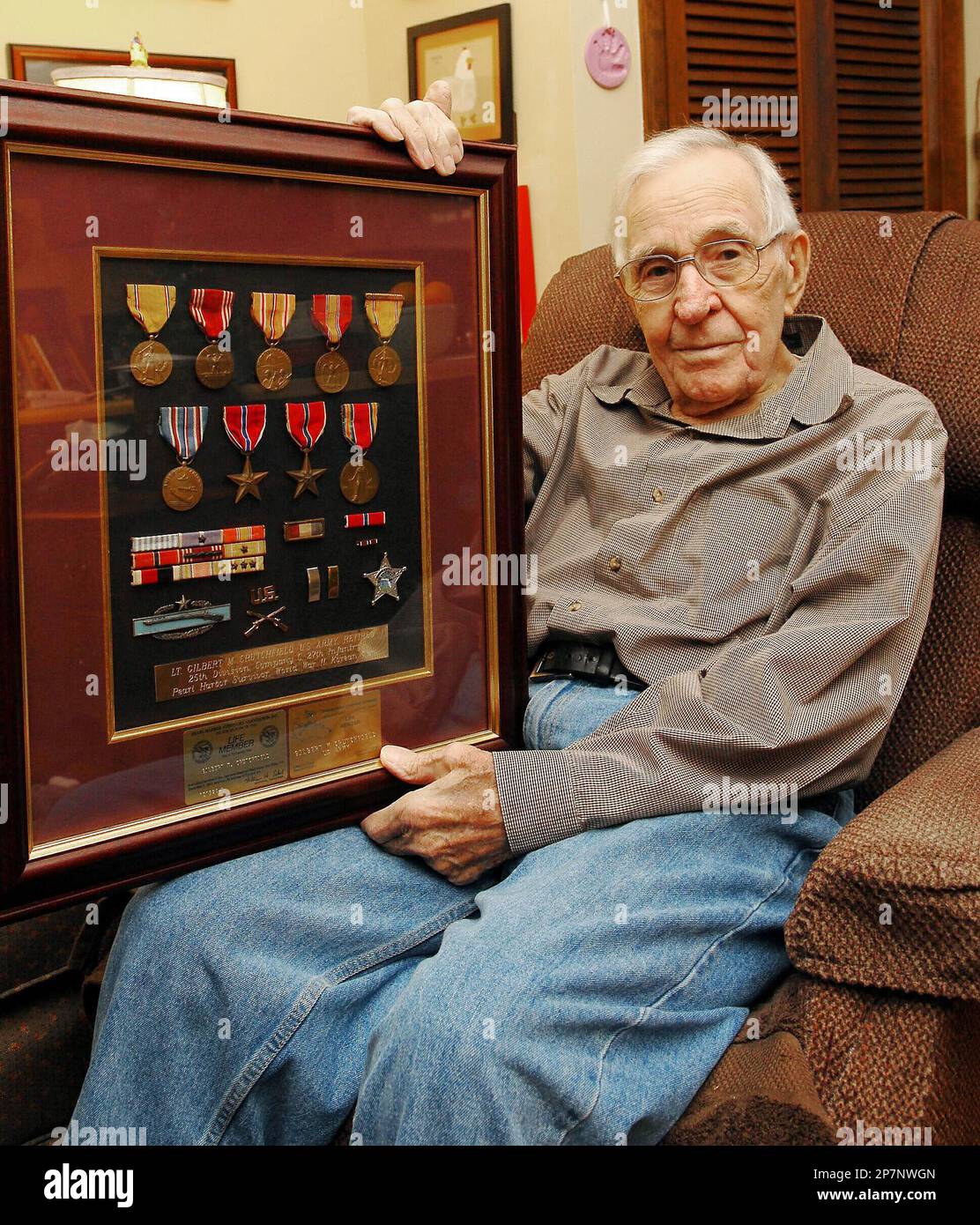 ** ADVANCE FOR SUNDAY DEC. 6 ** Gilbert Crutchfield, holds his medals ...