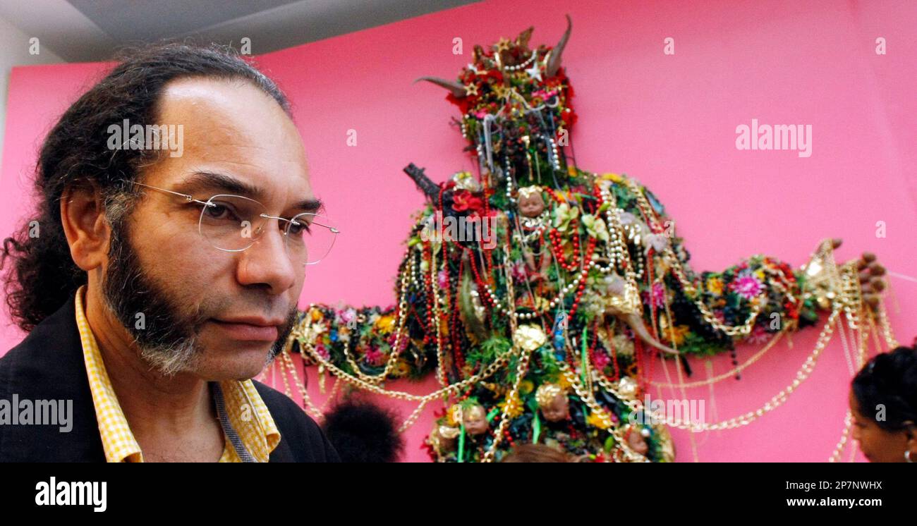 Artist Hew Locke, of Guyana, talks to a reporter at the opening of "The ...