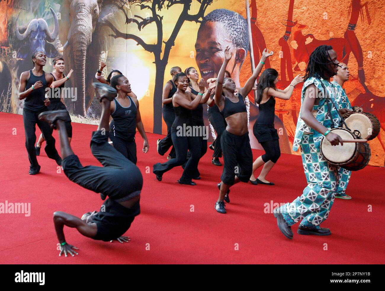 Dancers perform on the red carpet as they arrive for the start of the ...