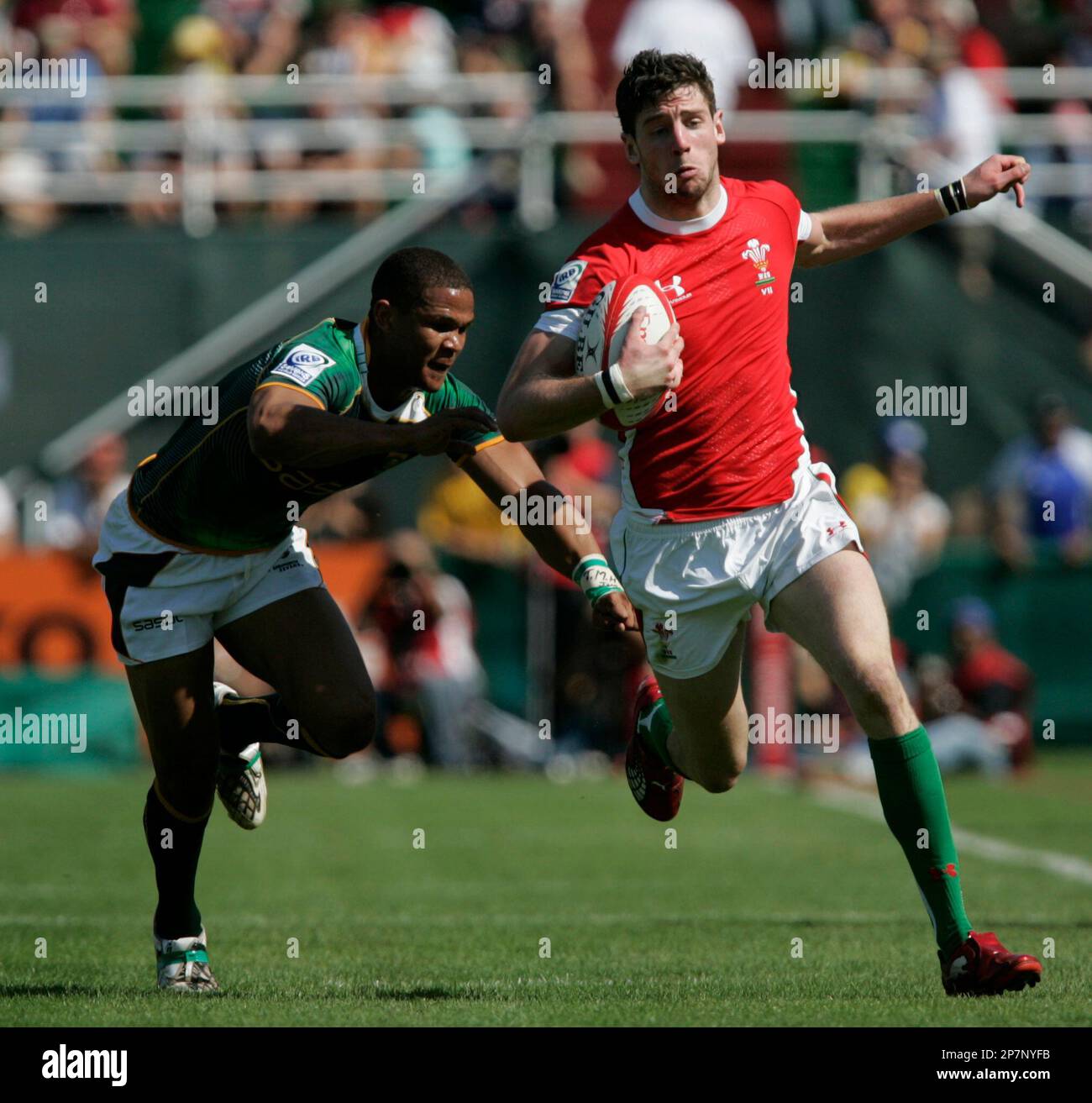 Alex Cuthbert of Wales (right) holds the ball as South Africa's Ryno ...