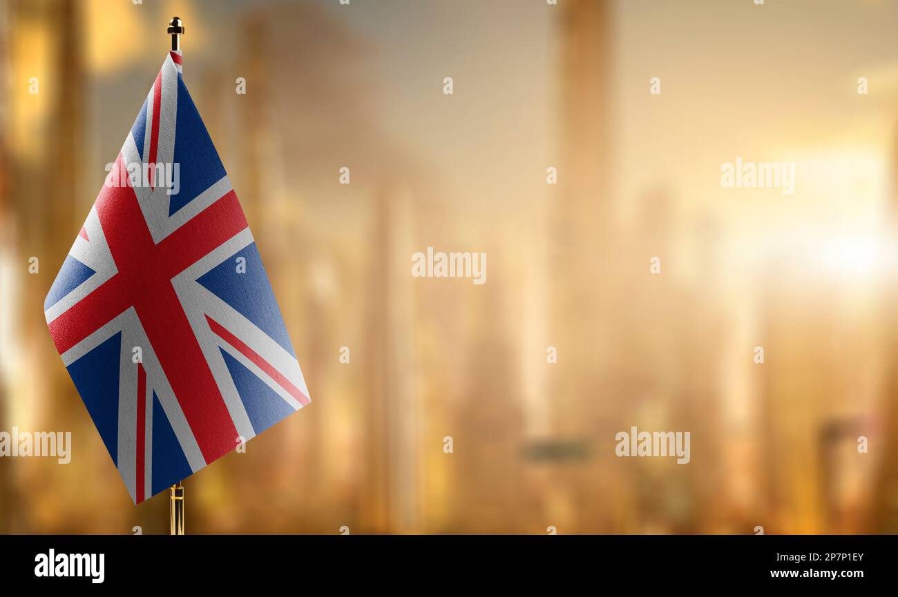 Small flags of the United Kingdom on an abstract blurry background ...