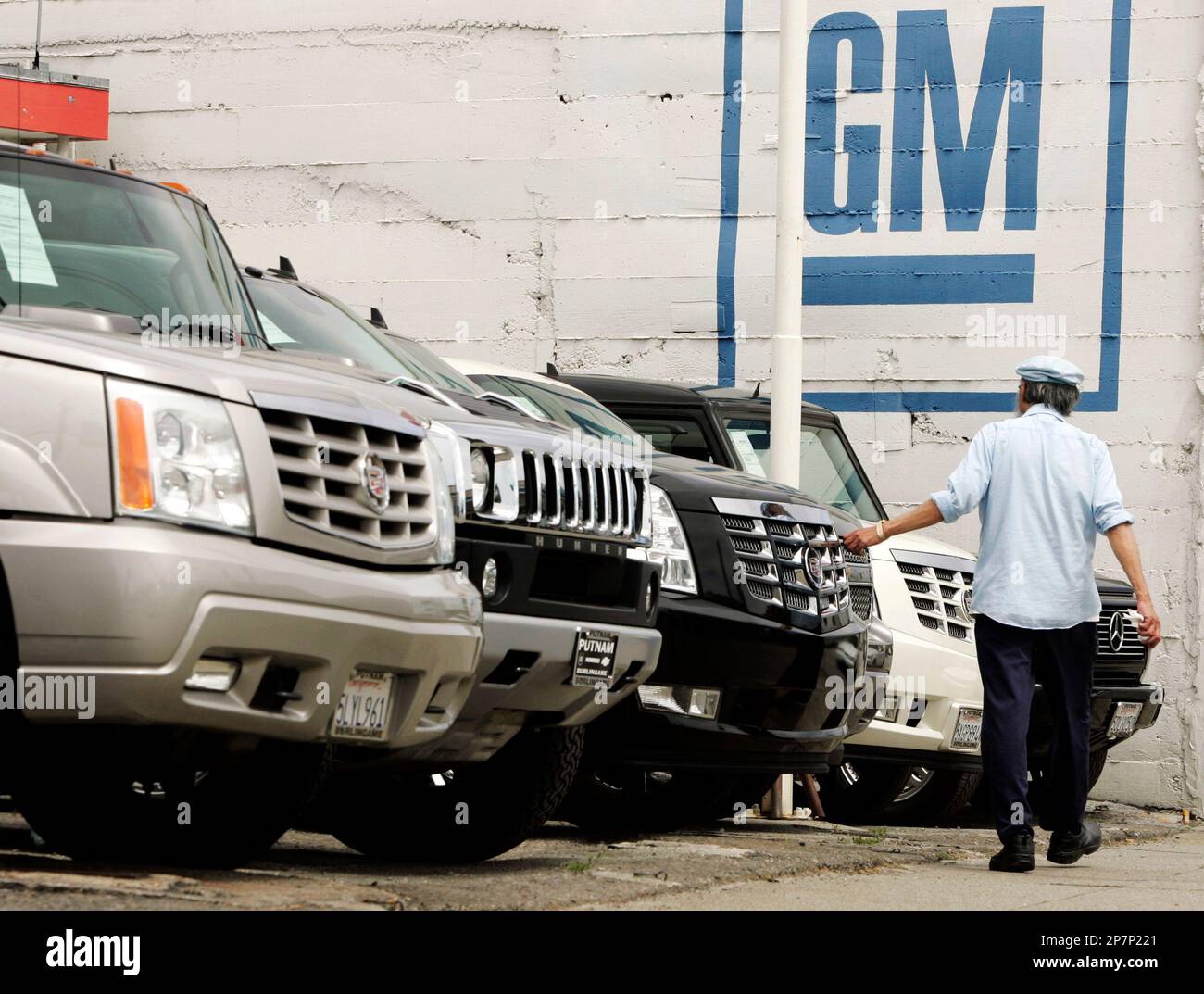 FILE - In this June 1, 2009 file photo, a customer looks at vehicles at ...