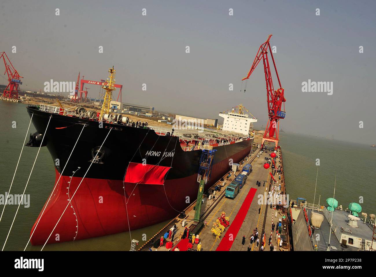 Workers celebrate during a handover ceremony of the 76,000-ton bulk ...