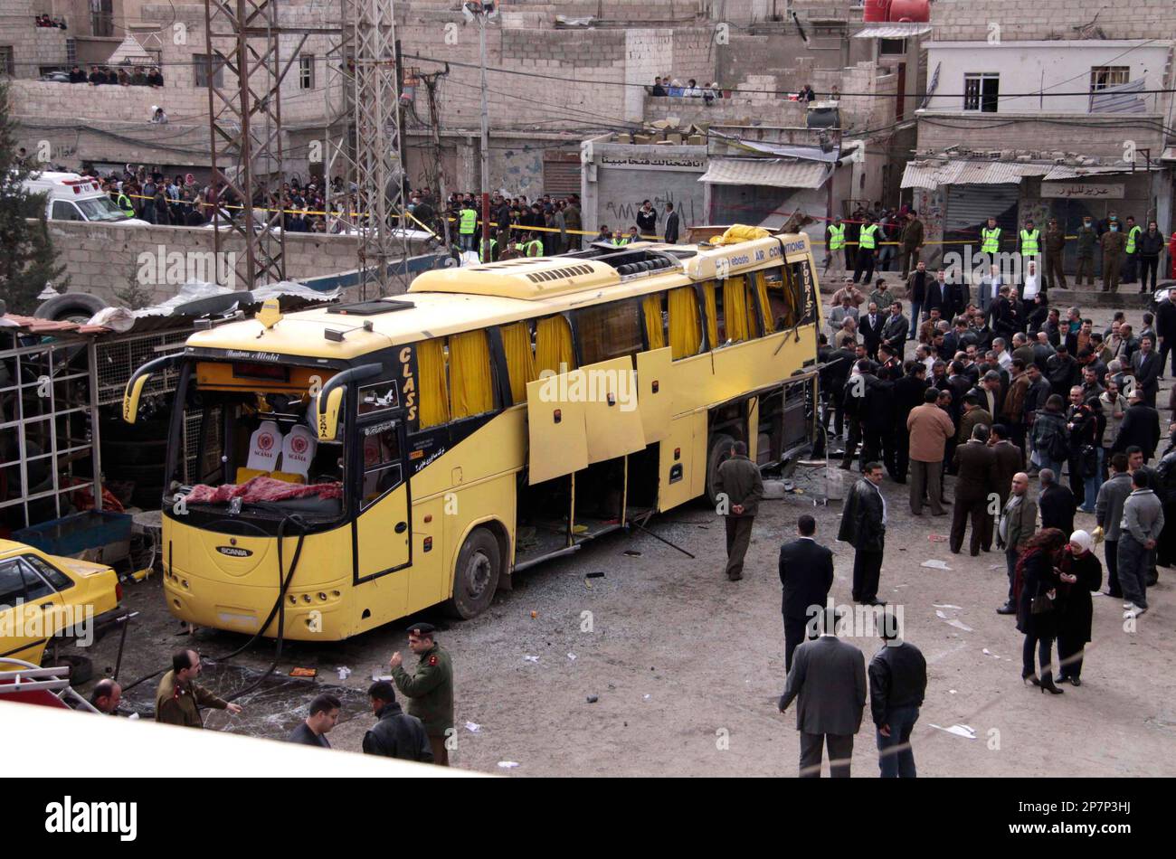 A damaged bus is seen at the site where three people were killed in al ...