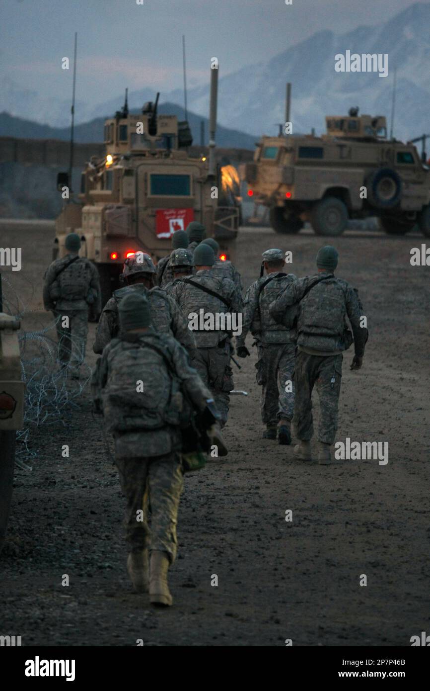 Soldiers belonging to Chaos Platoon walk at the motor pool before ...