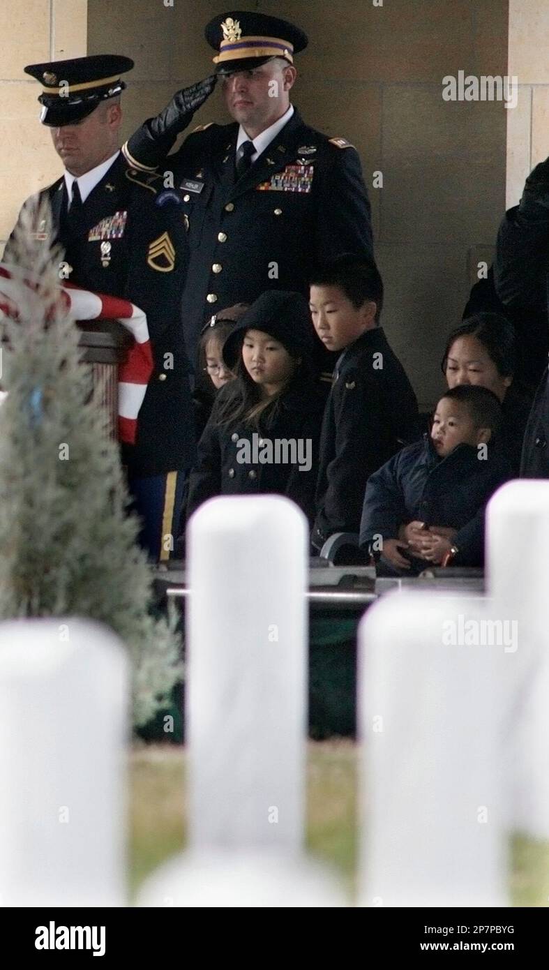 Family members watch as the casket for Pfc. Kham Xiong arrives at Fort ...
