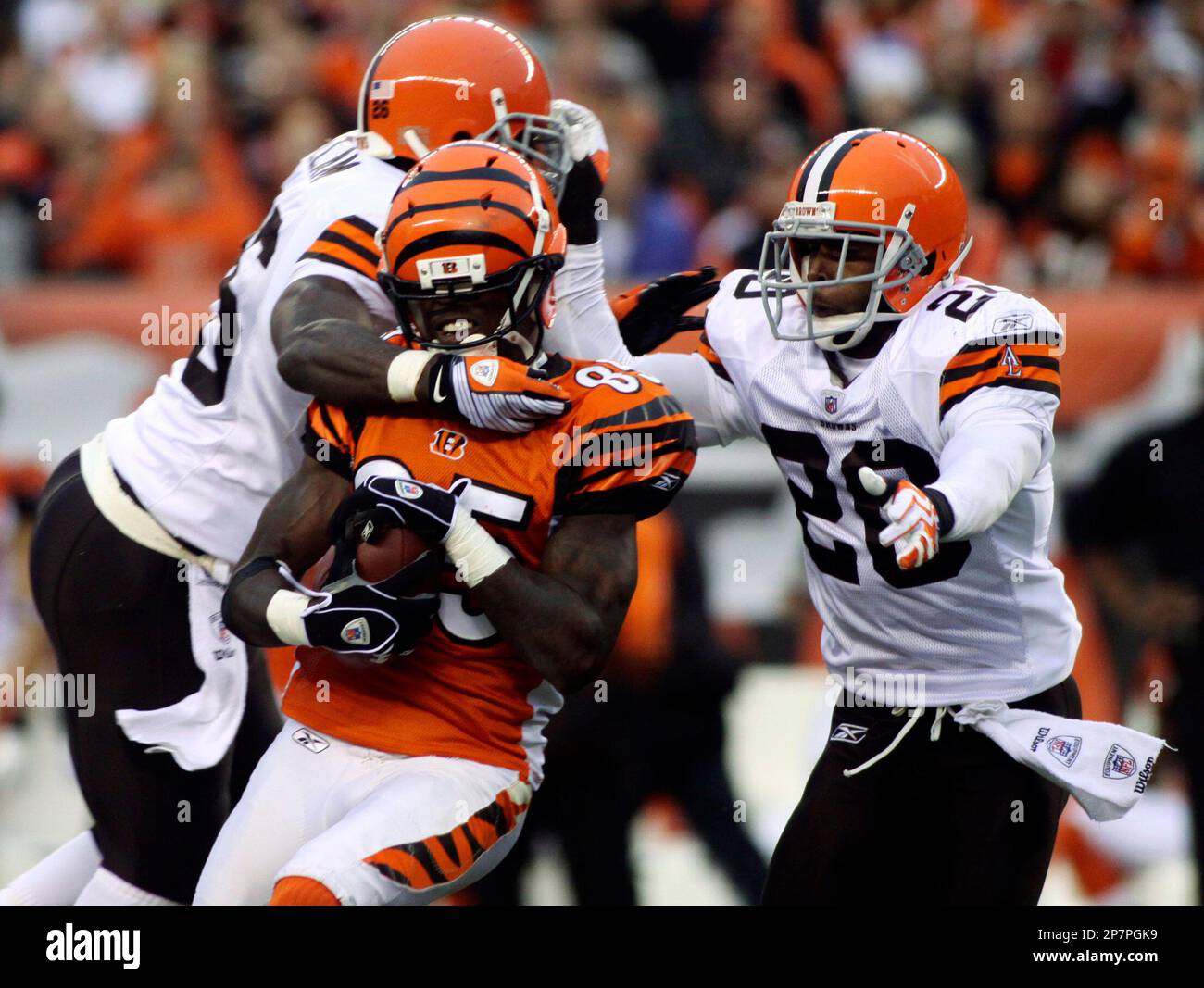Cincinnati Bengals wide receiver Chad Ochocinco, center, is tackled by ...