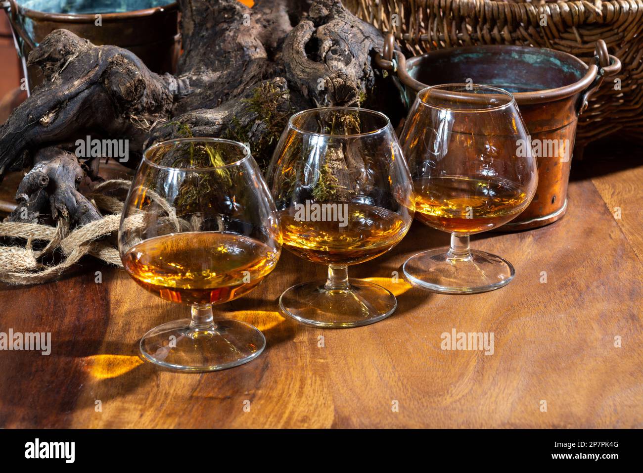 Tasting glasses of aged french cognac brandy alcoholic drink in old ...