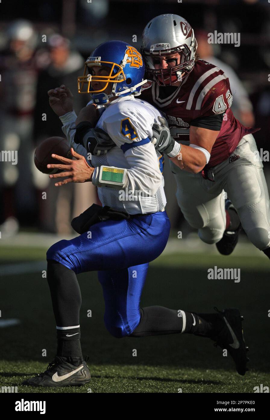 Montana defensive end Jace Palmer (42) forces a fumble by South Dakota ...