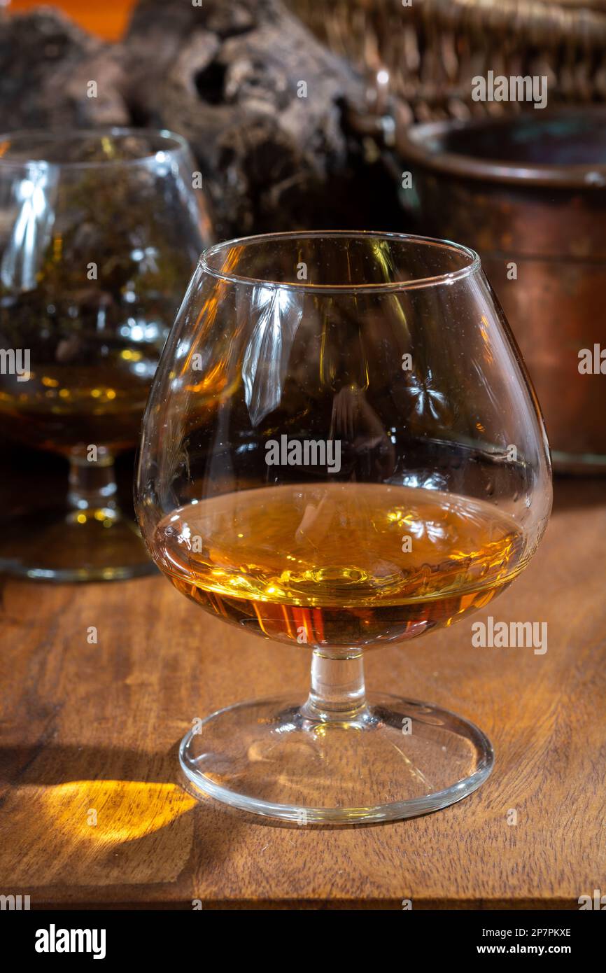 Tasting glasses of aged french cognac brandy alcoholic drink in old ...