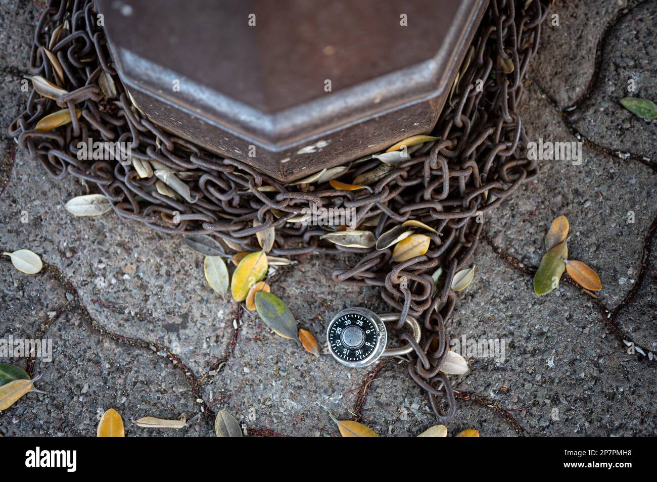 A top view of metal chains lying on the ground tied with of a numeric ...