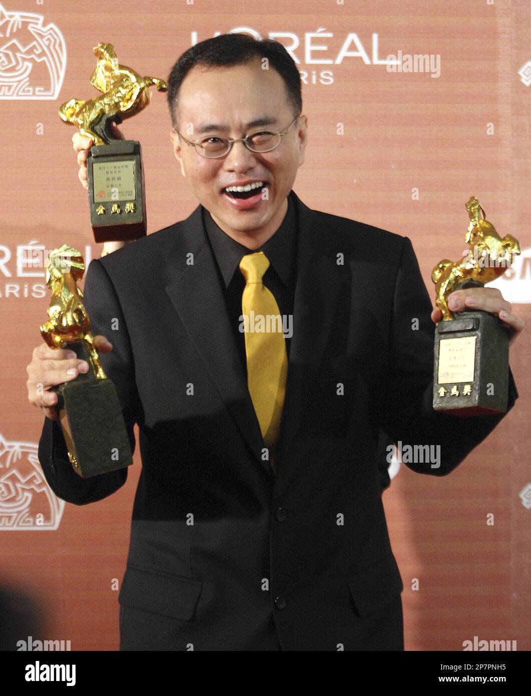 Hong Kong director Cheung King-wai smiles with three awards he won at ...