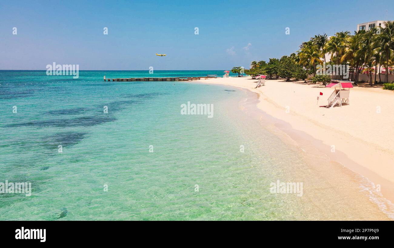 The beautiful blue waters and white sand beaches of Doctor's Cave Beach ...