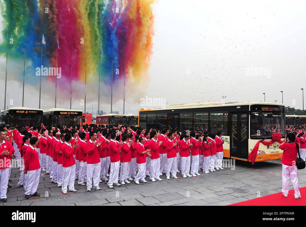 Bus drivers in new uniforms stand next to the new special buses for ...