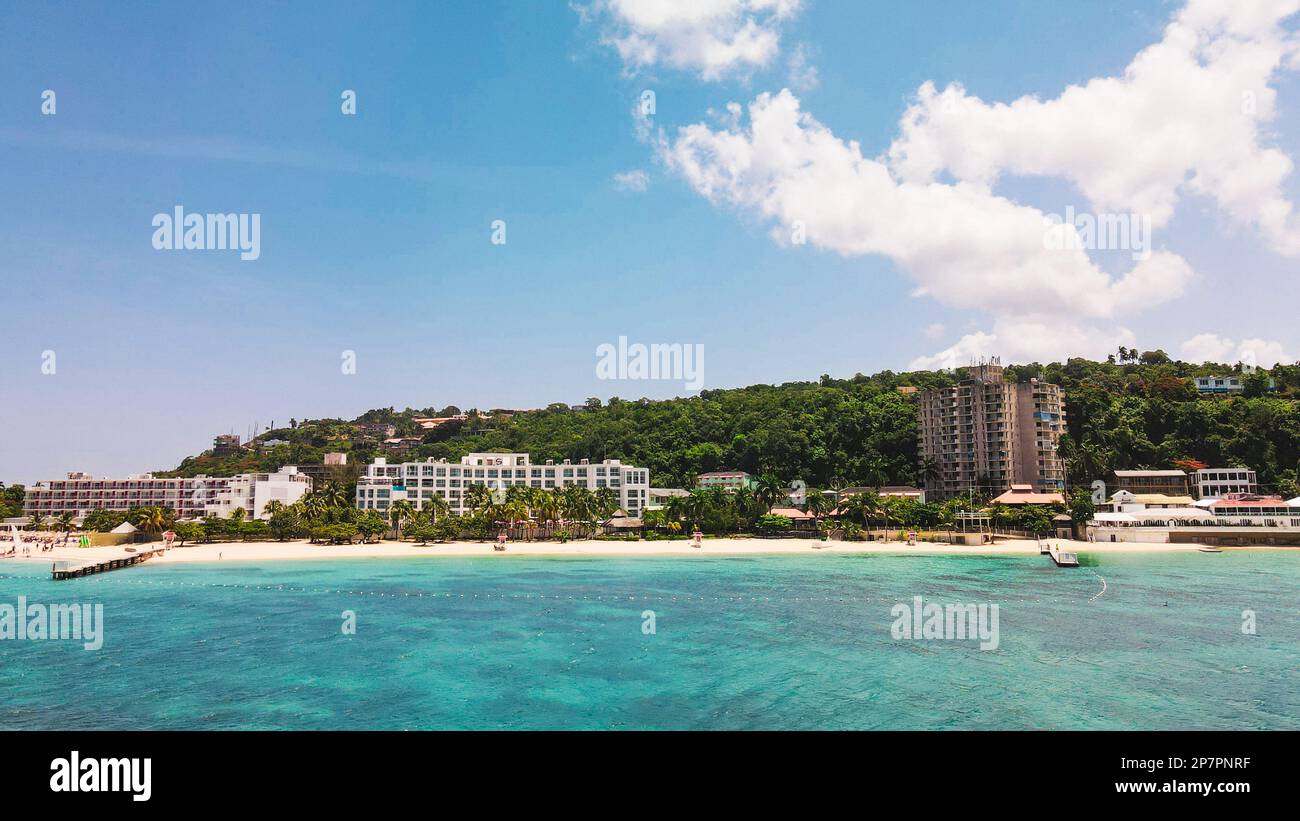 The beautiful blue waters and white sand beaches of Doctor's Cave Beach ...