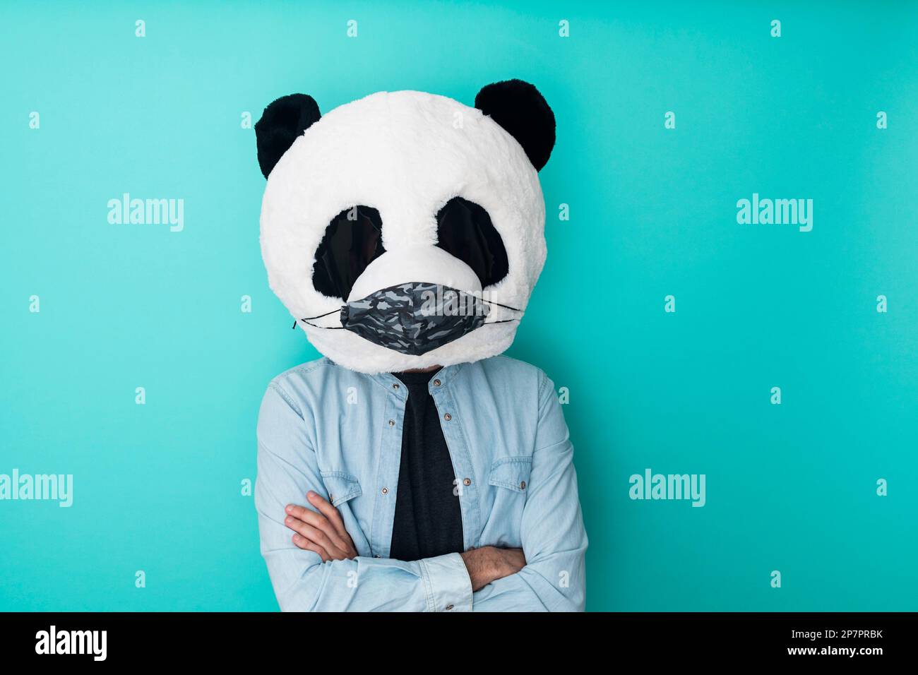 Man in panda mask wearing protective face mask with crossed arms in ...
