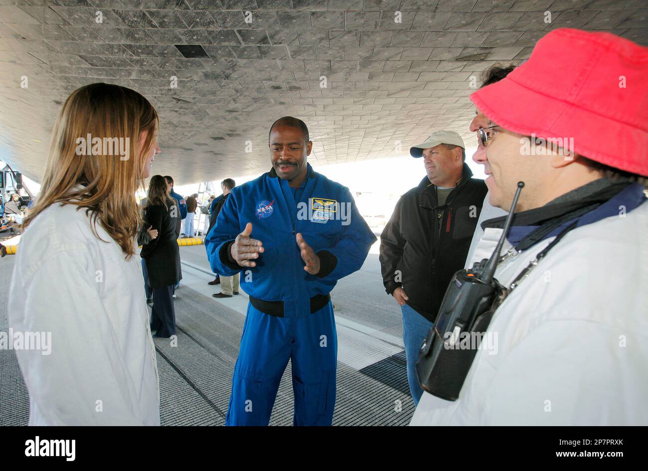 Mission Specialist Leland Melvin, second from left, talks with runway ...